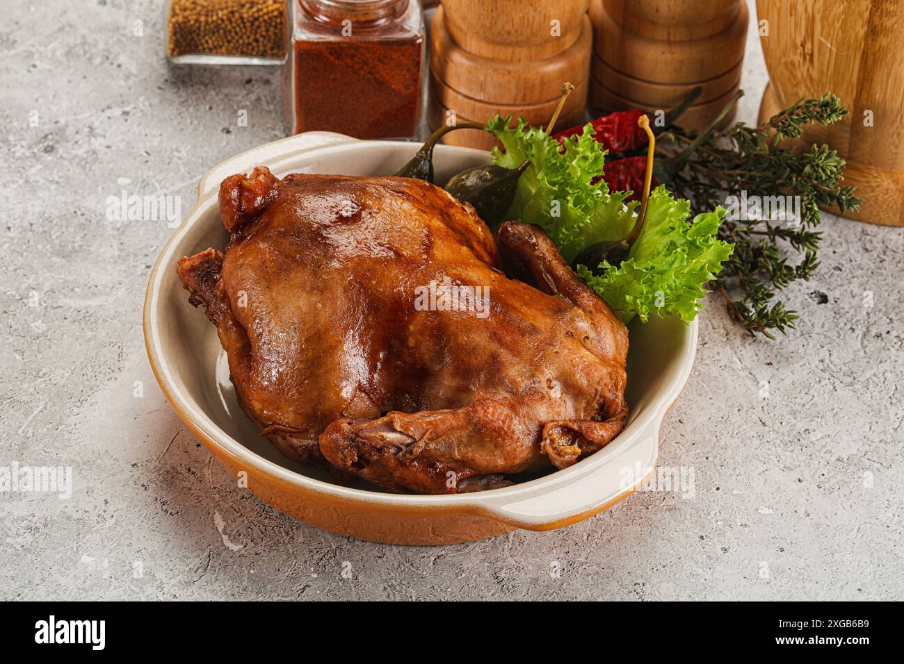Baked whole small chicken with spices Stock Photo - Alamy