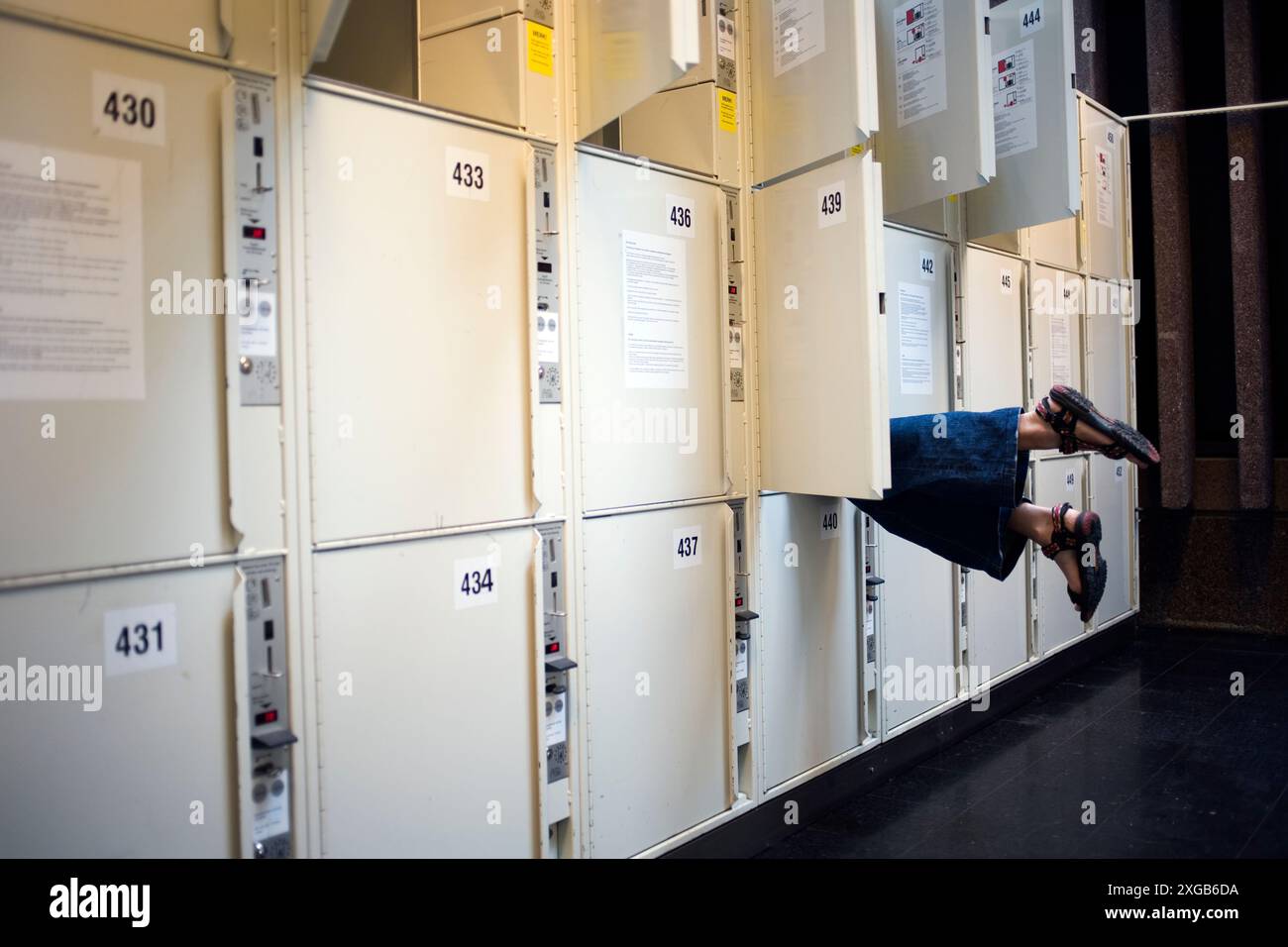 Two feet stick out of a row of lockers in a train station in Denmark ...