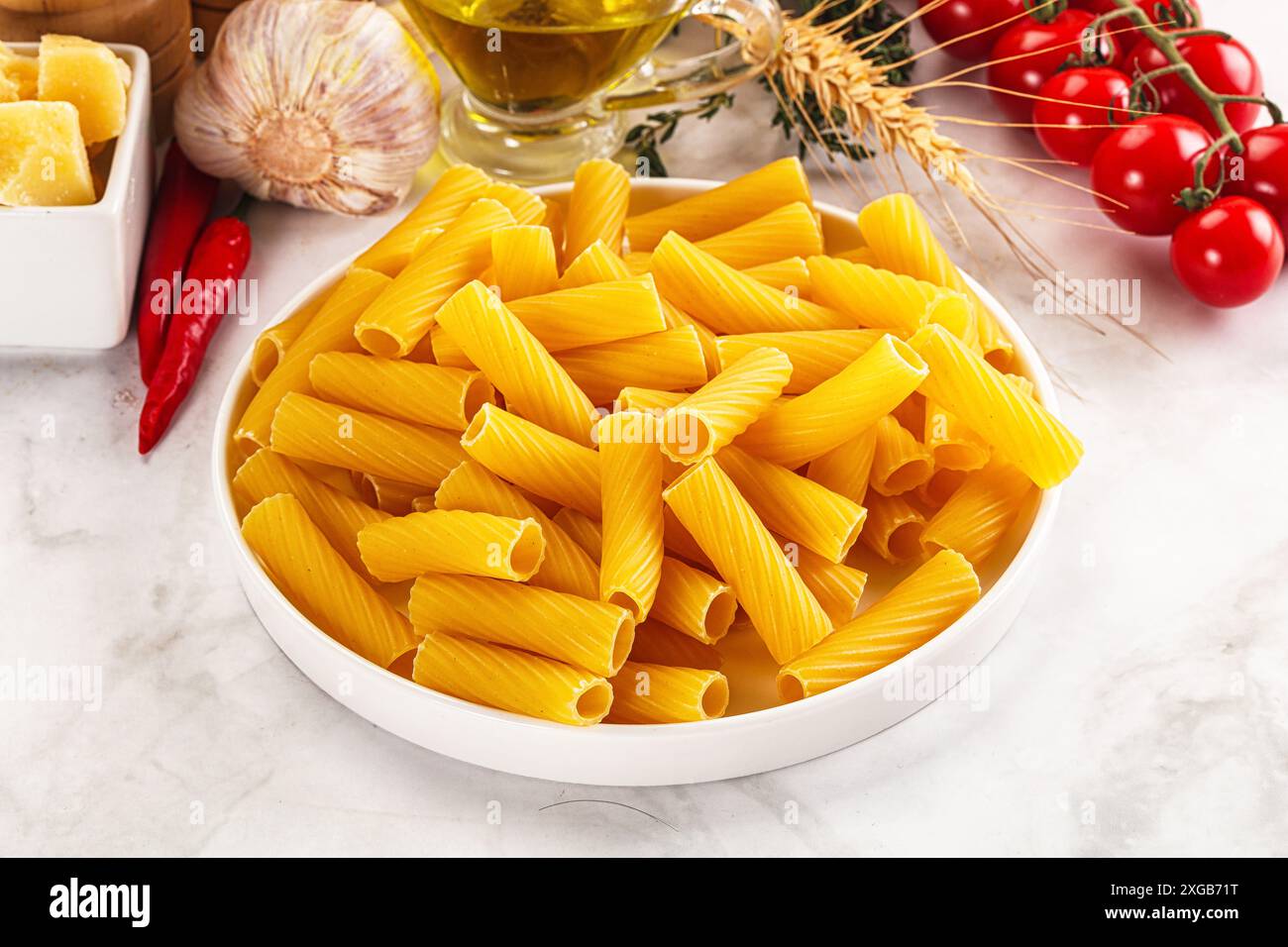Italian cuisine - raw dry tortiglioni pasta Stock Photo - Alamy