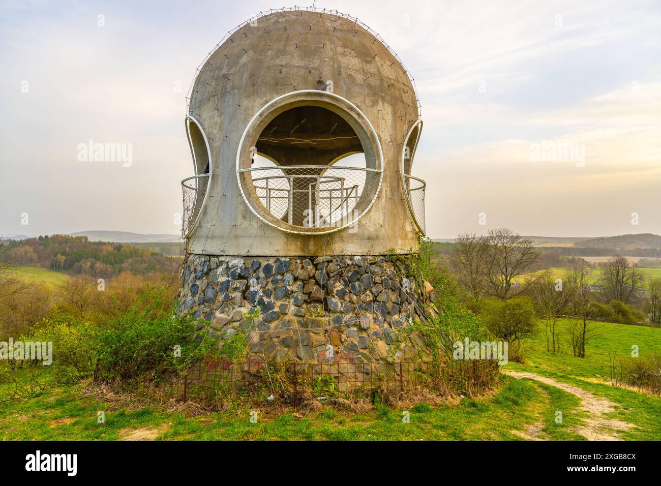 A unique modern concrete lookout tower with large circular windows ...