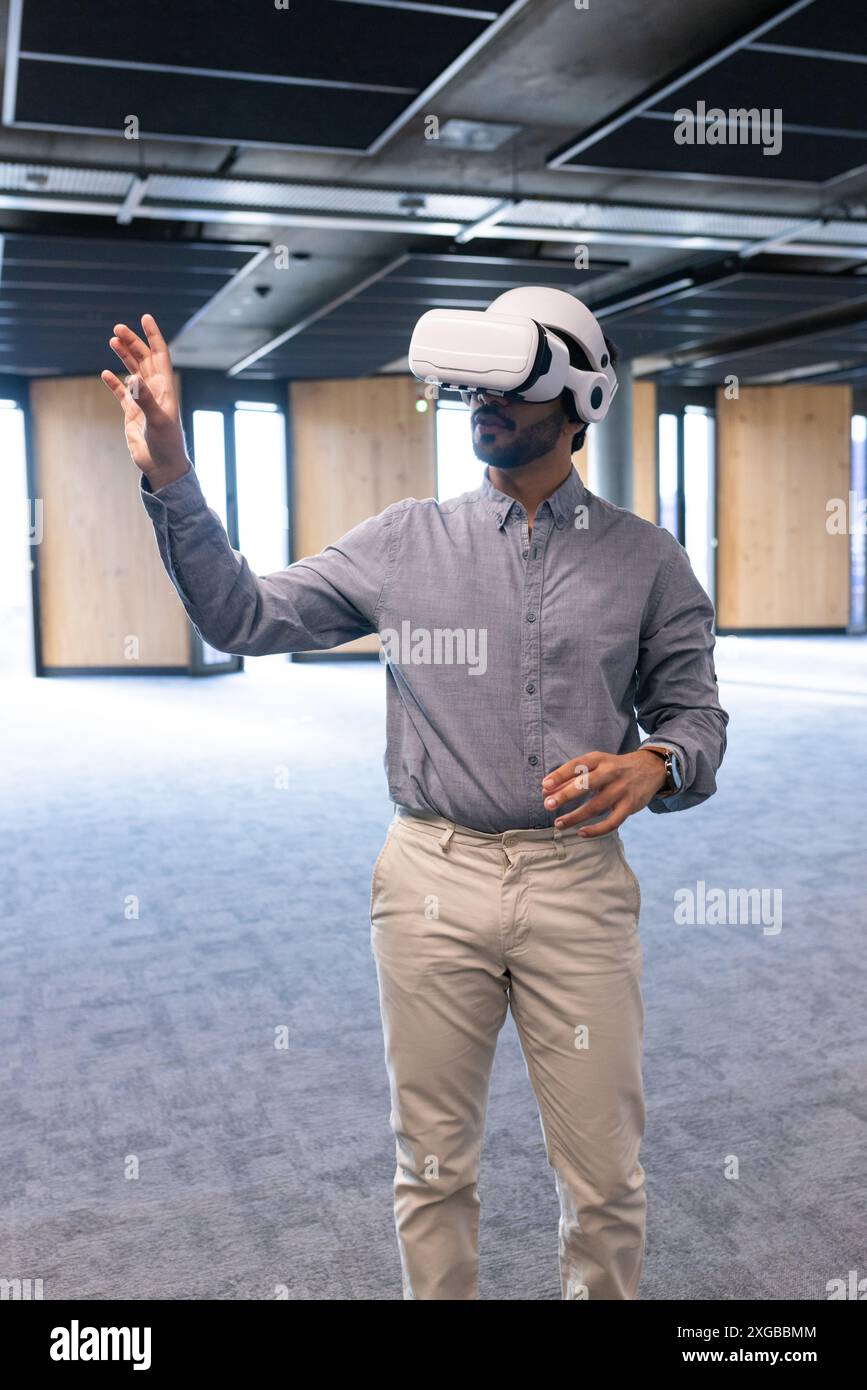 Using VR headset, man interacting with virtual environment in modern ...