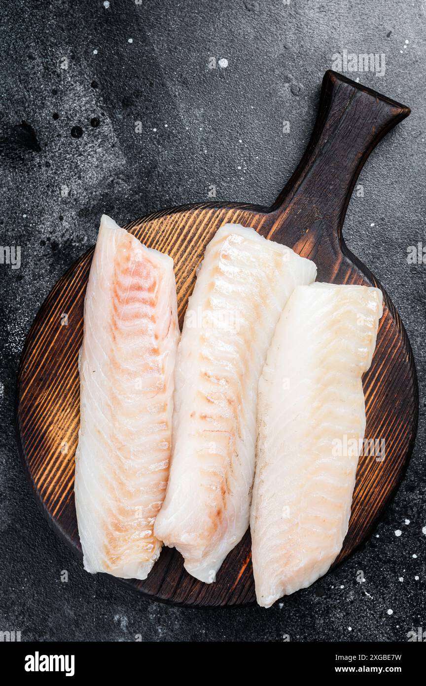 Fillets of codfish, raw cod fish meat. Black background. Top view Stock ...