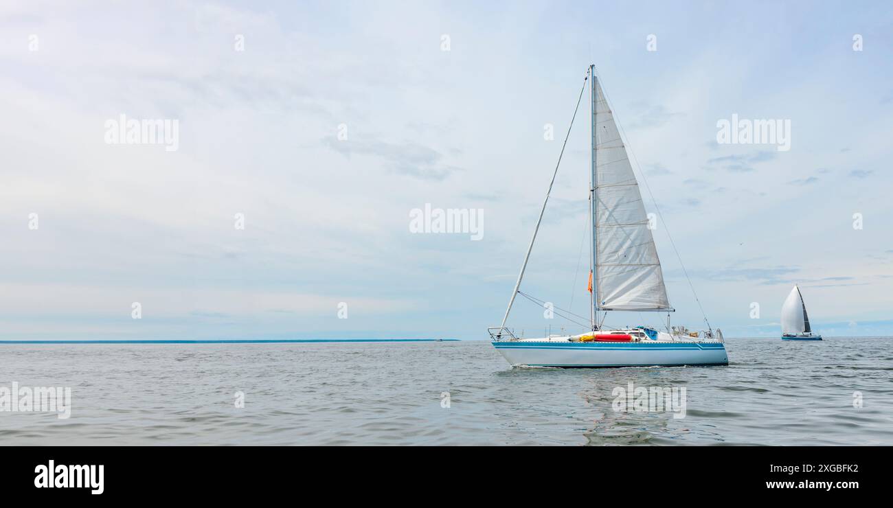 Yacht sailing at waves of the open sea. Nautical landscape with ...