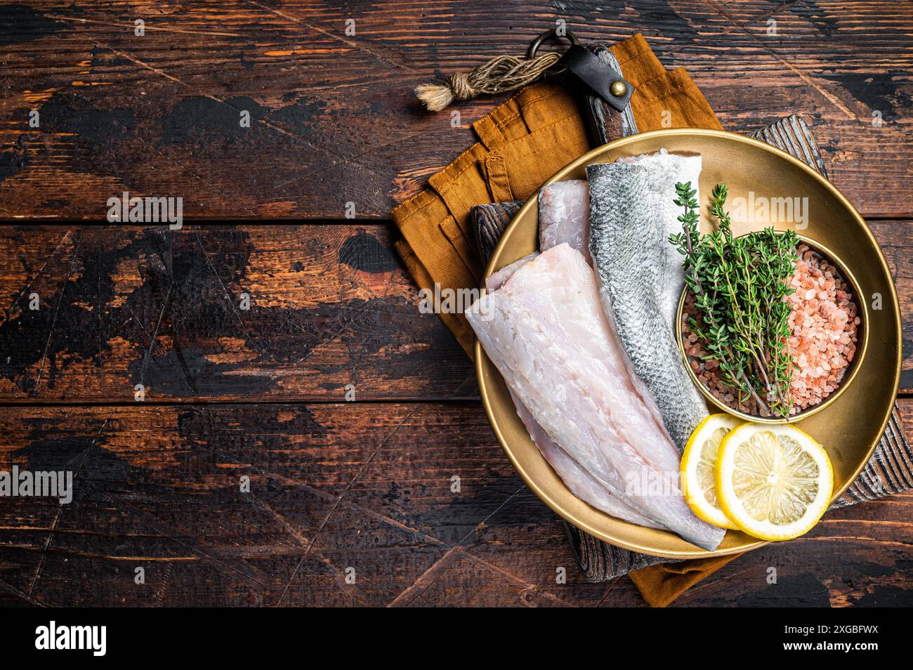 Uncooked Raw Sea Bass fillets, Seabass fish with thyme, pink salt and ...