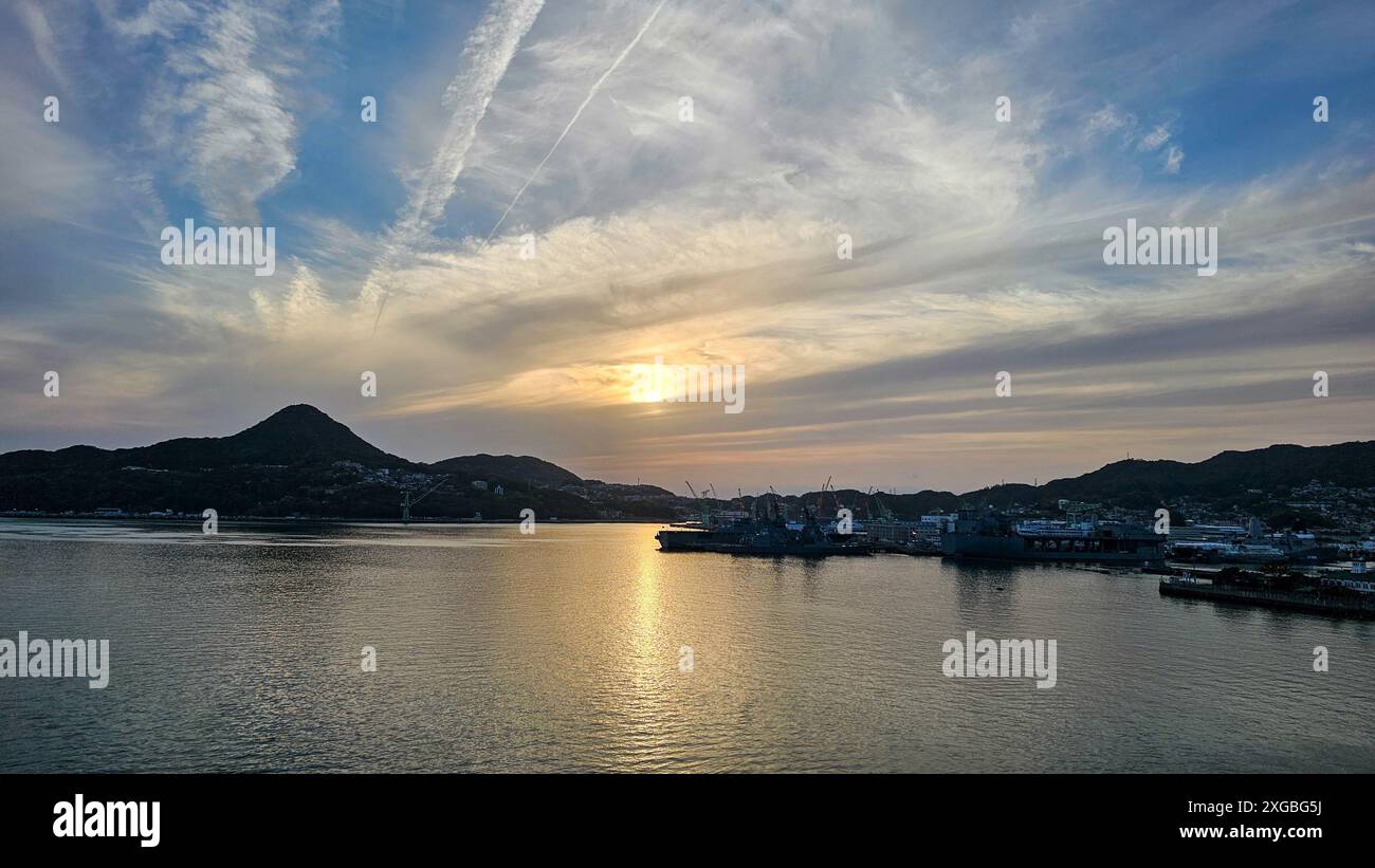 The Sunset over a harbor with mountains in Sasebo, Nagasaki Stock Photo ...