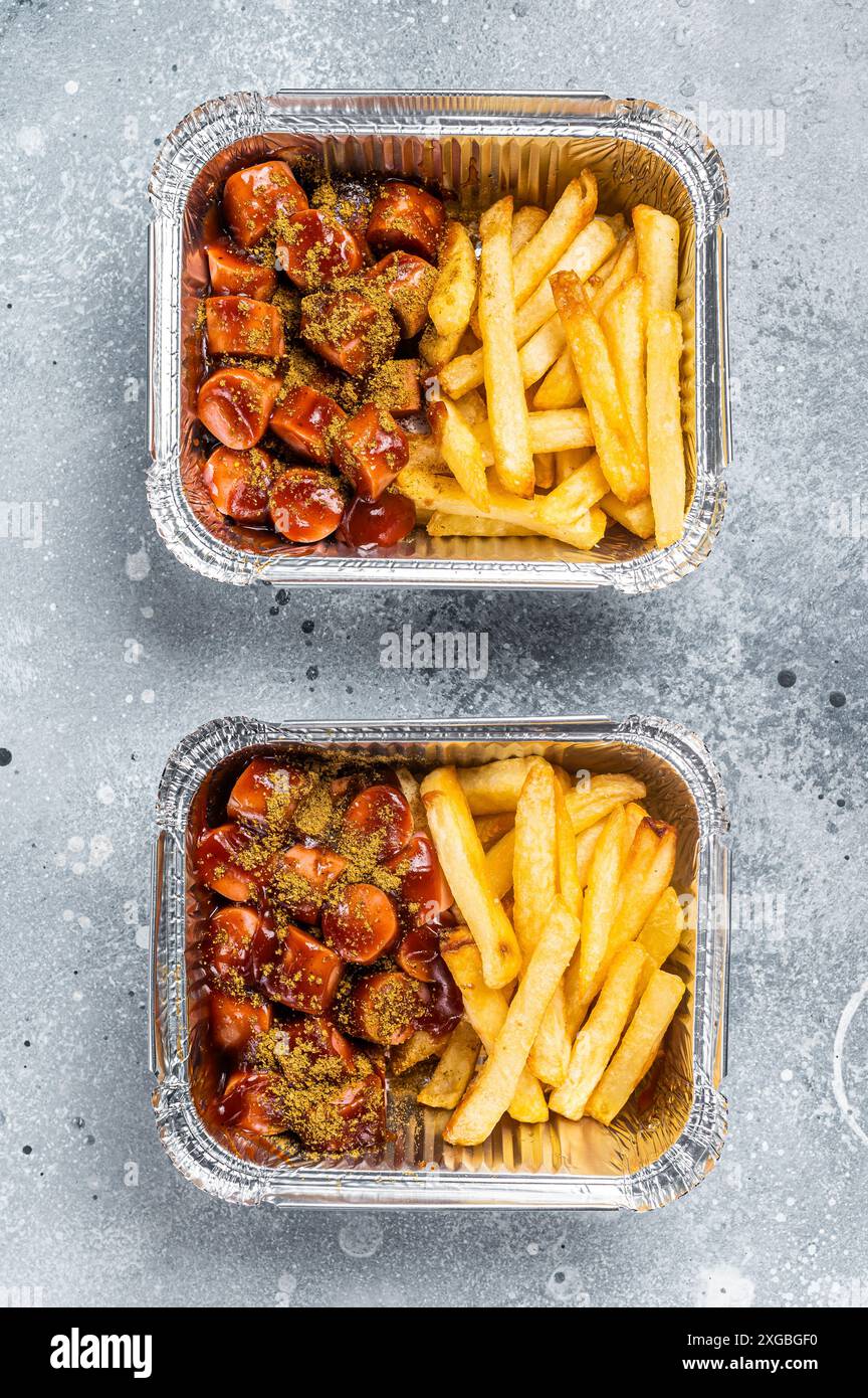 Traditional German currywurst with french fry served take away. Gray ...