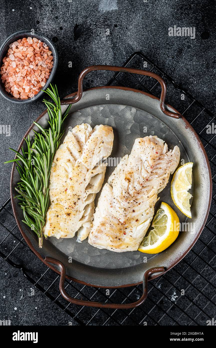 Roast Fillets of codfish, cooked cod fish meat. Black background. Top ...