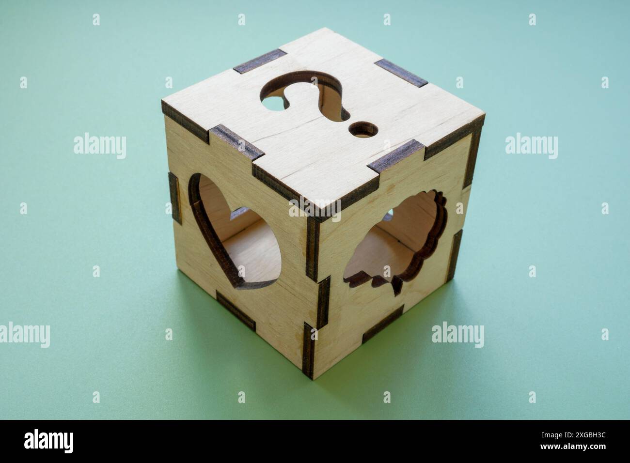 EQ and IQ concept. A cube with a question mark, a heart and a brain ...