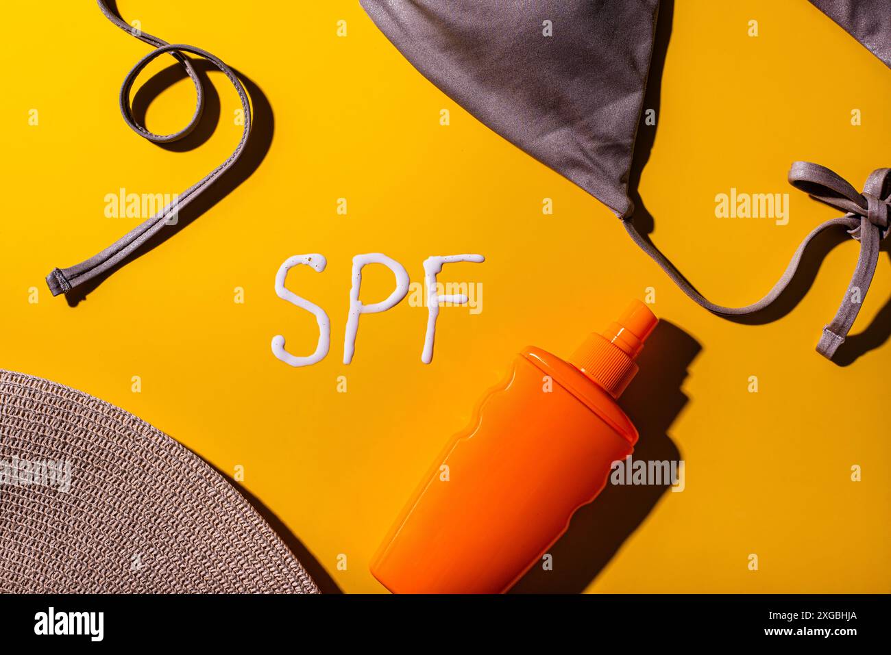Sunscreen SPF cream on yellow background Stock Photo - Alamy
