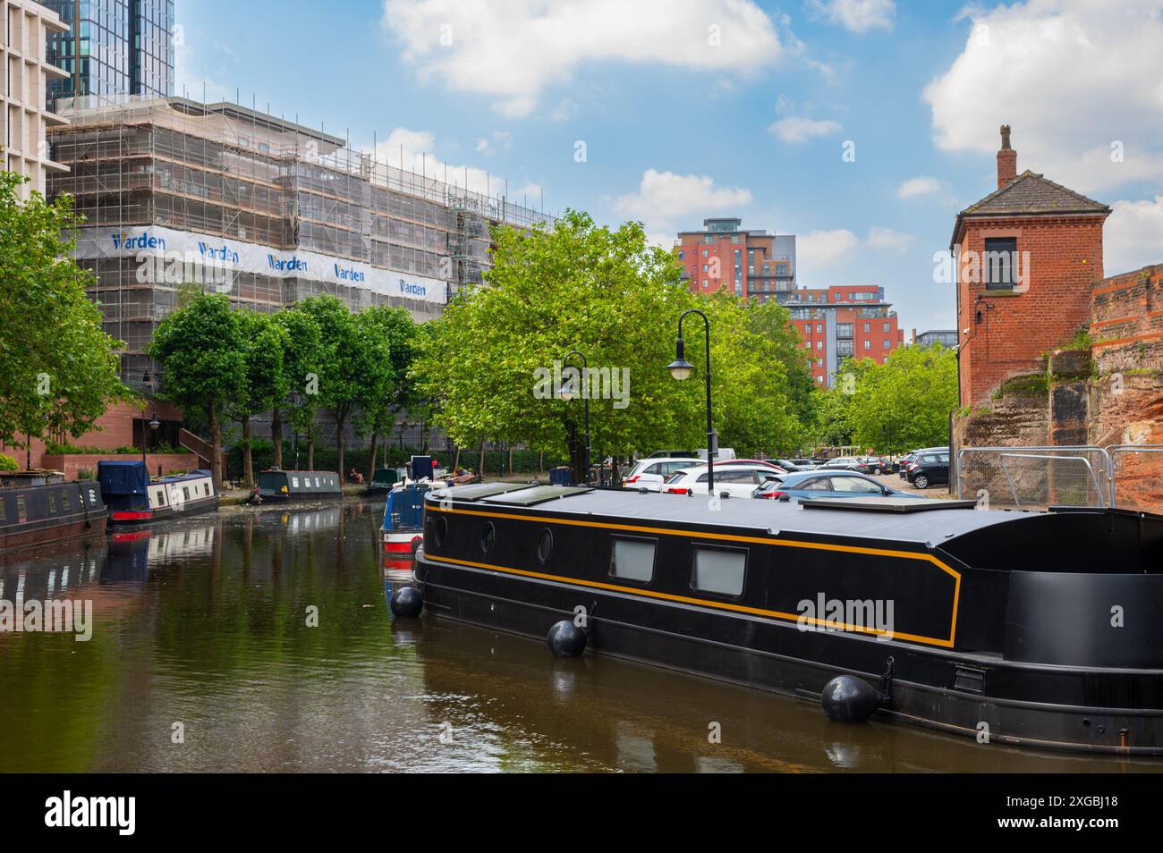 Black barge, lift bridge and trees at Castlefield Bridgewater Canal ...