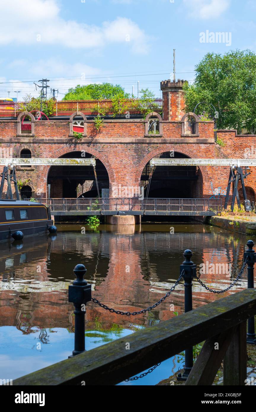 Black barge, lift bridge and trees at Castlefield Bridgewater Canal ...