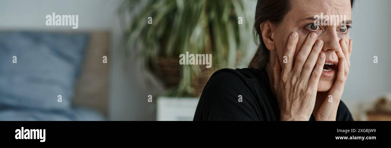 A middle-aged woman covering her face with her hands in despair Stock ...
