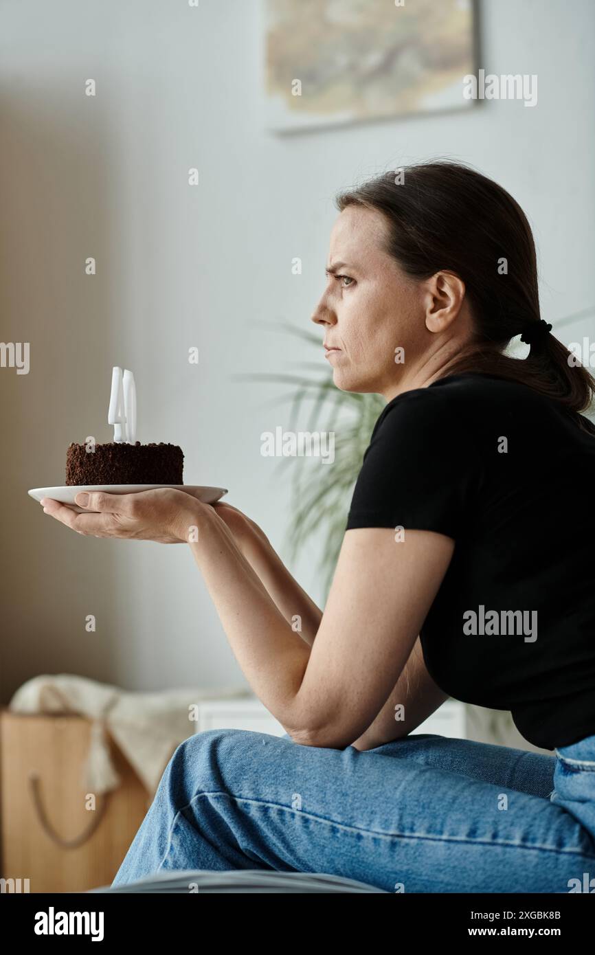 Woman sitting on couch holding hi-res stock photography and images - Alamy