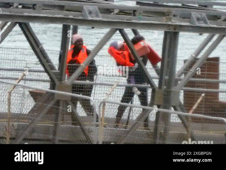 A group of people thought to be migrants are brought in to Dover, Kent ...