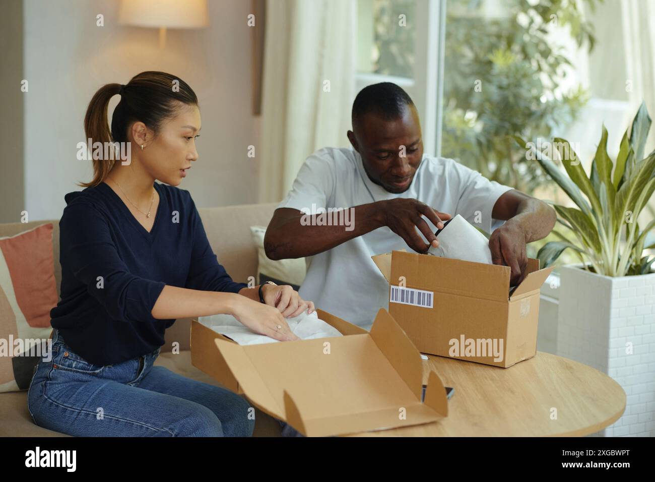 Couple opening boxes goods hi-res stock photography and images - Alamy