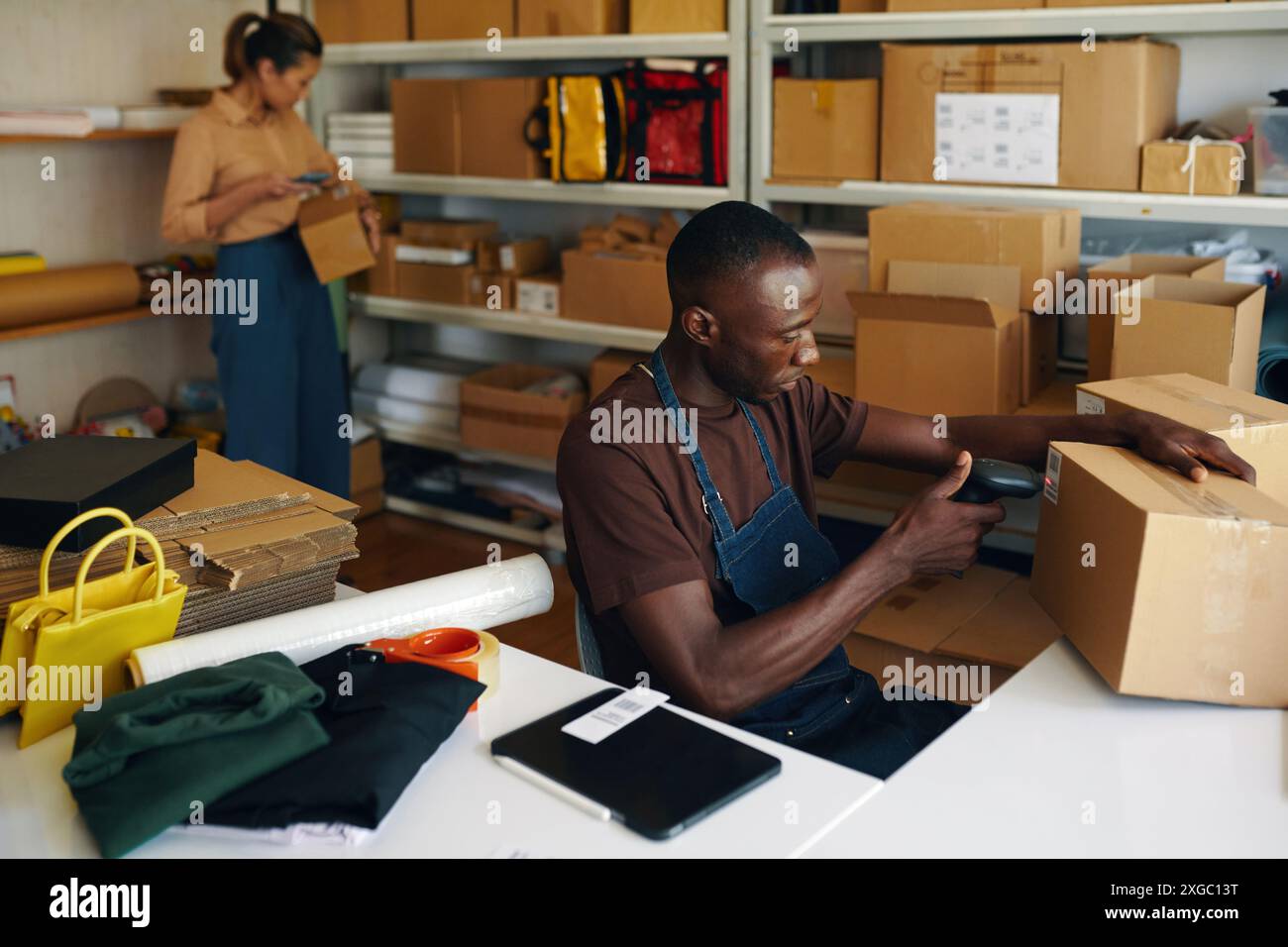 People Scanning Barcodes On Parcels In Warehouse Stock Photo - Alamy