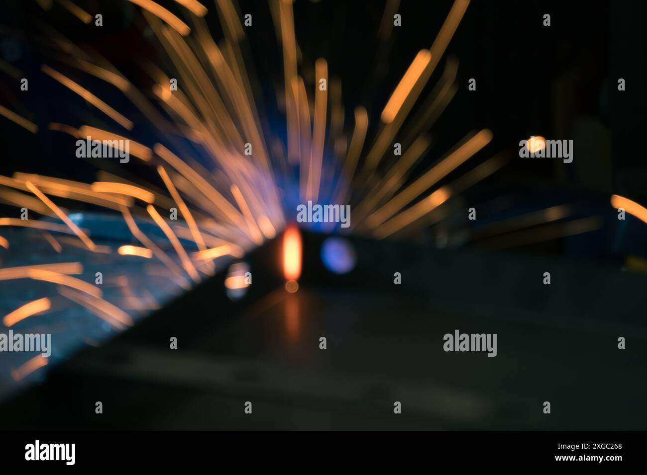 Detail of heavy industry manufacturing, sparks come out of a metal ...