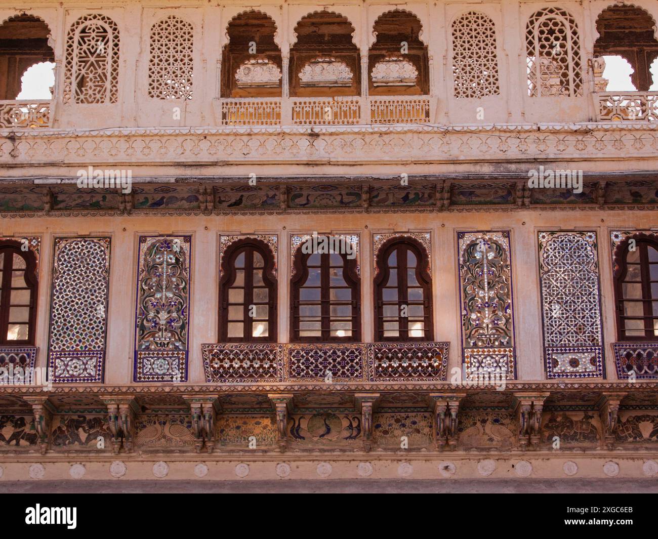 A section of windows, balconies and stone jalis incorporated in the ...