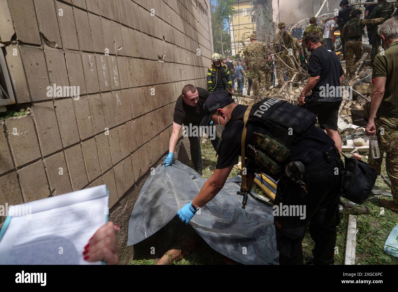 Police officer covers a dead body after a Russia's missiles attack in ...