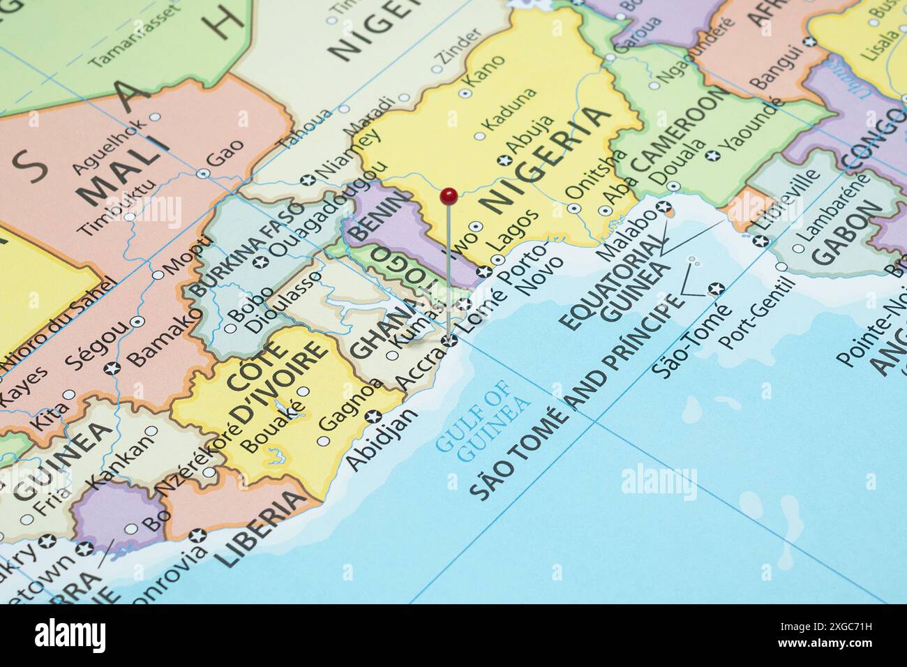 Close up to a Accra city with a red pin needle into Ghana country ...