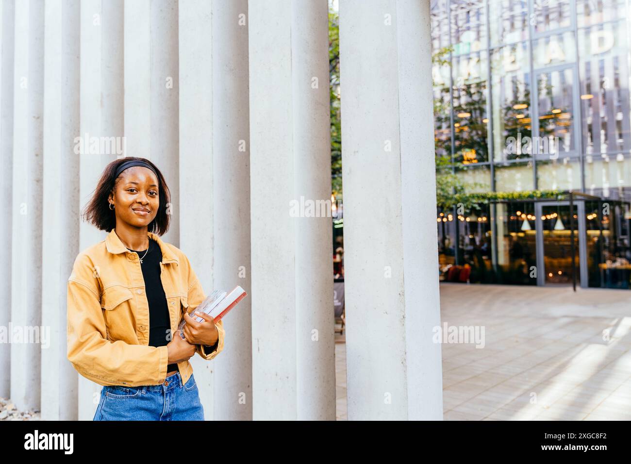 African girl with happy face learner studying on campus or walking ...