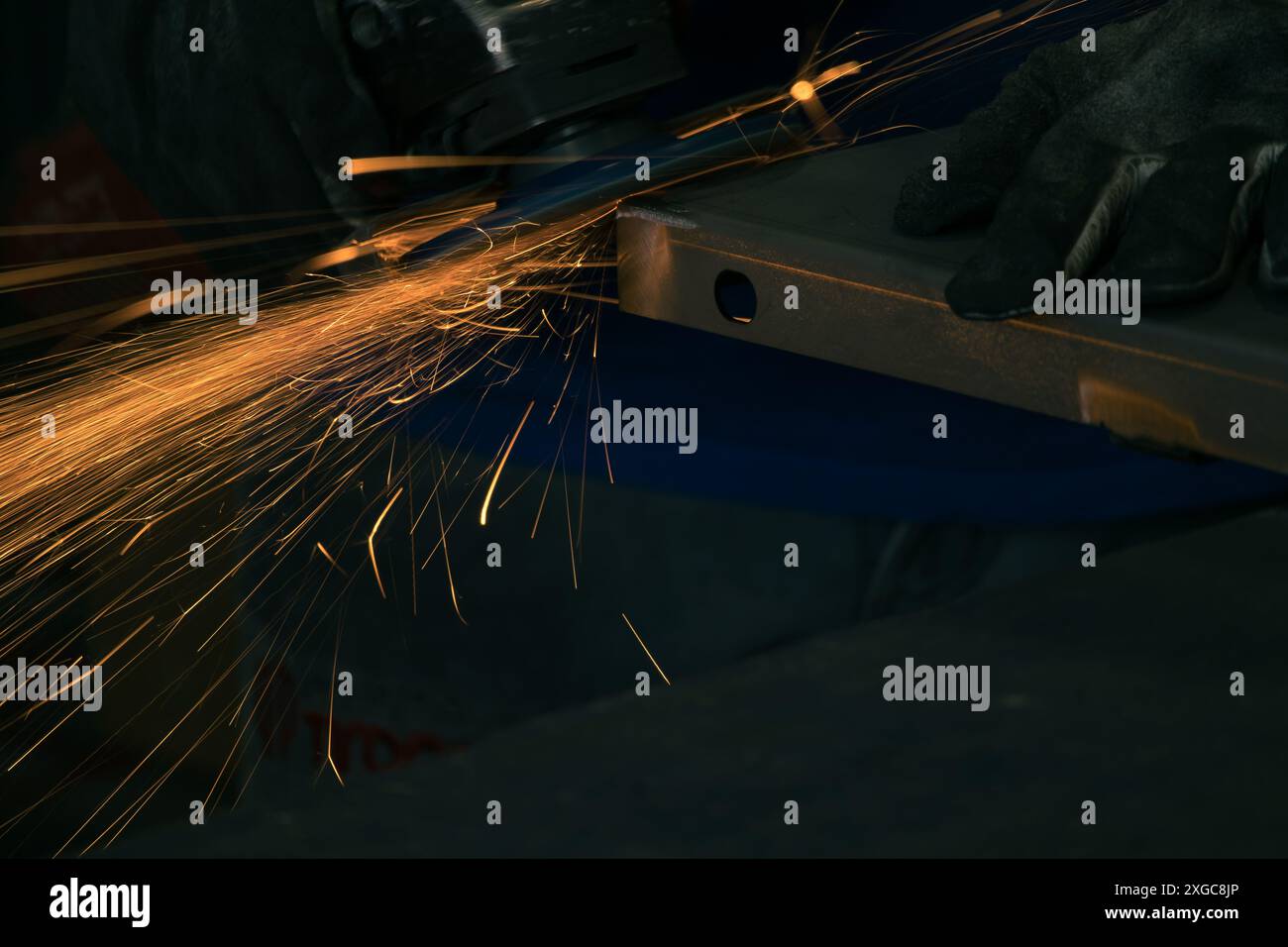 Detail of heavy industry manufacturing, sparks come out of a metal ...
