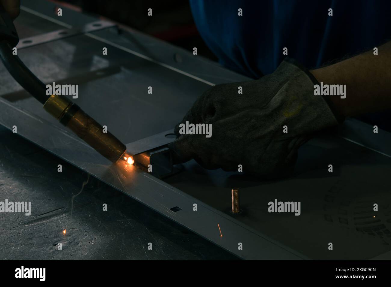 Detail of heavy industry manufacturing, sparks come out of a metal ...