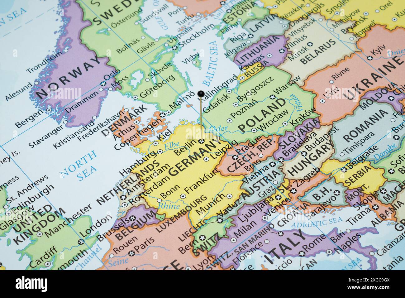 Close up to a Berlin city with a black pin needle into Germany country ...