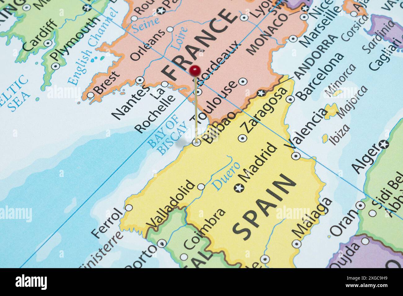 Close up to a Bilbao city with a red pin needle into Spain country ...