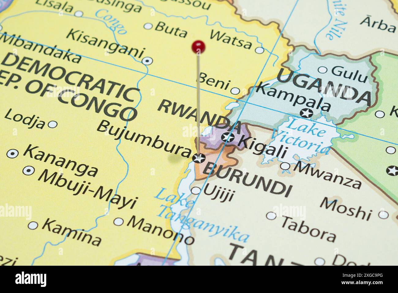 Close up to a Bujumbura city with a red pin needle into Burundi country ...