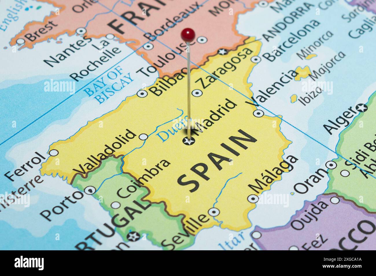 Macro photo of Madrid city with a red pin needle into Spain country ...