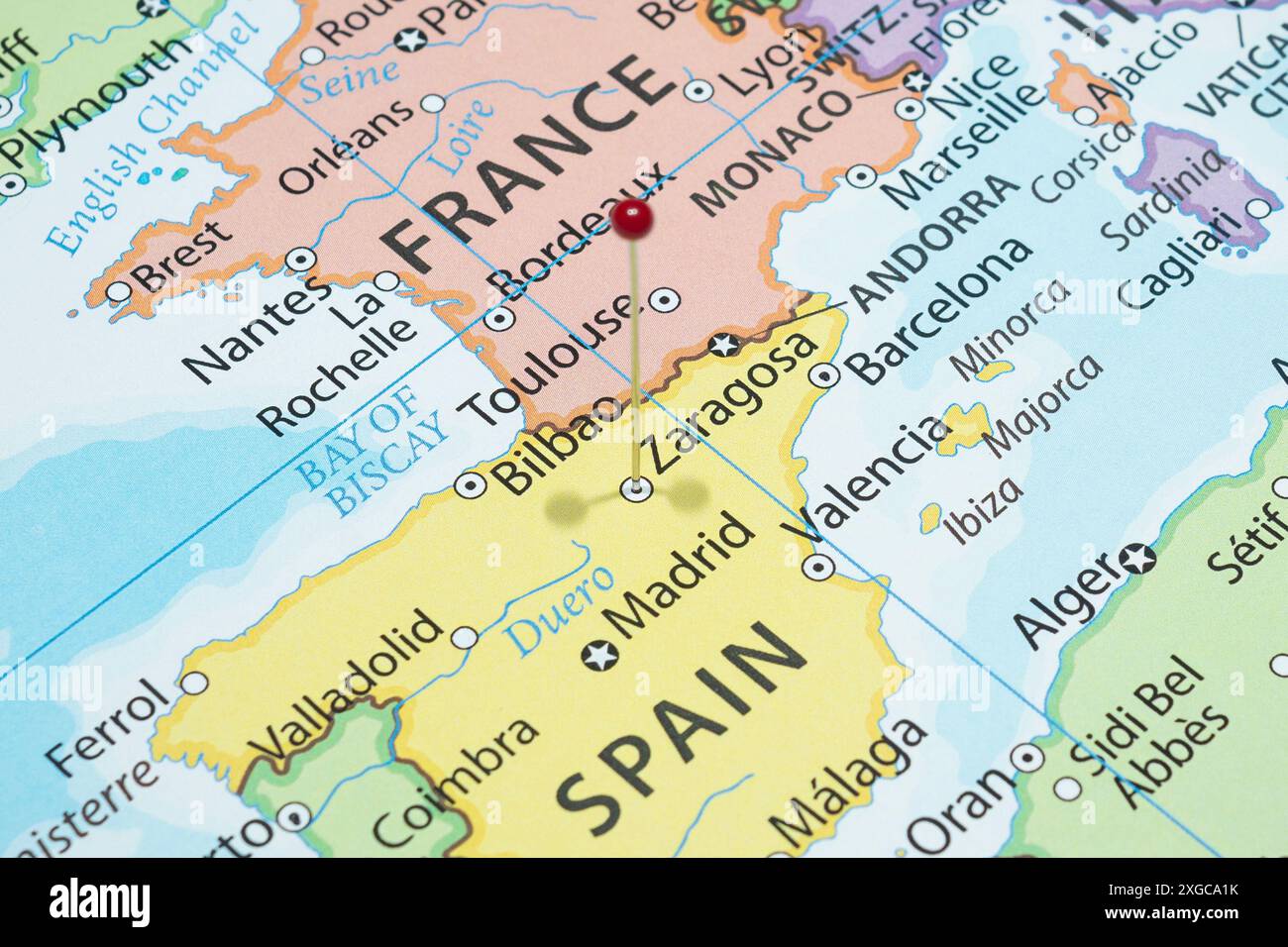 Close up to a Zaragoza city with a red pin needle into Spain country ...