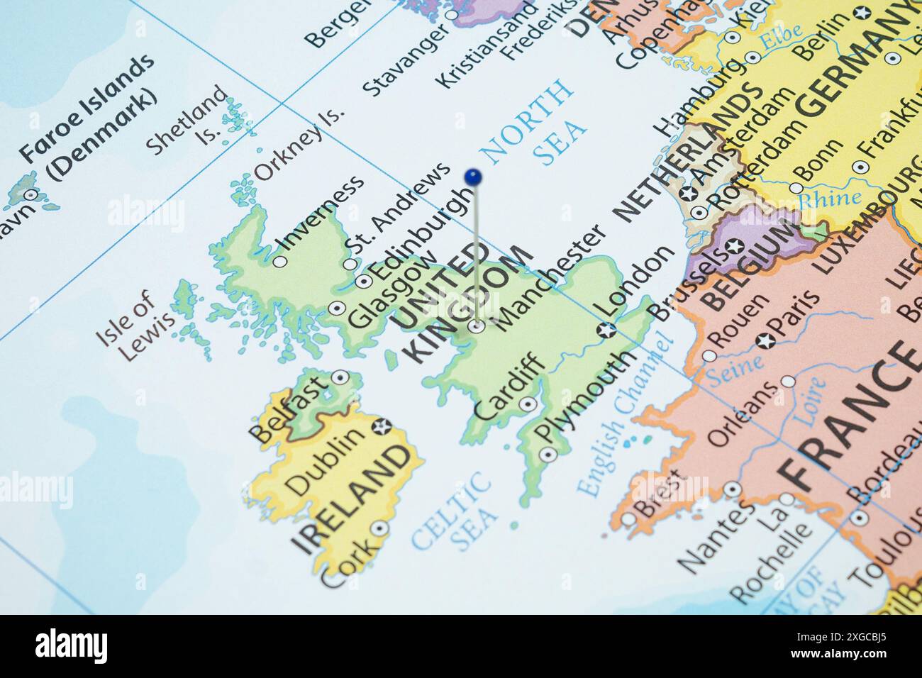 Close up to a Manchester city with a blue pin needle into England ...
