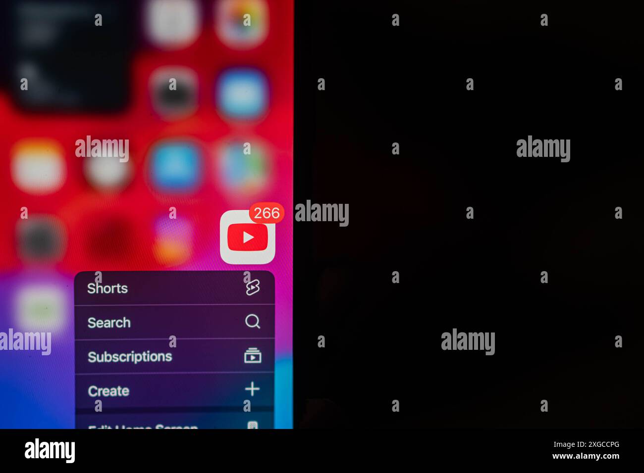 A smart phone screen displaying the YouTube app icon with 266 notifications. The background is ...