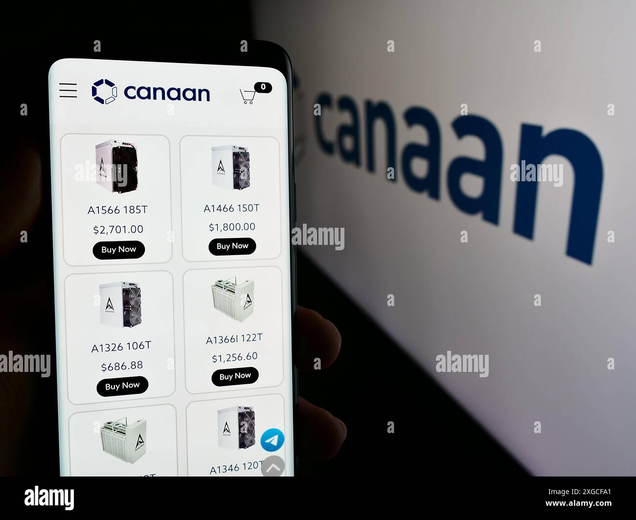 Person holding mobile phone with web page of Chinese computer hardware ...