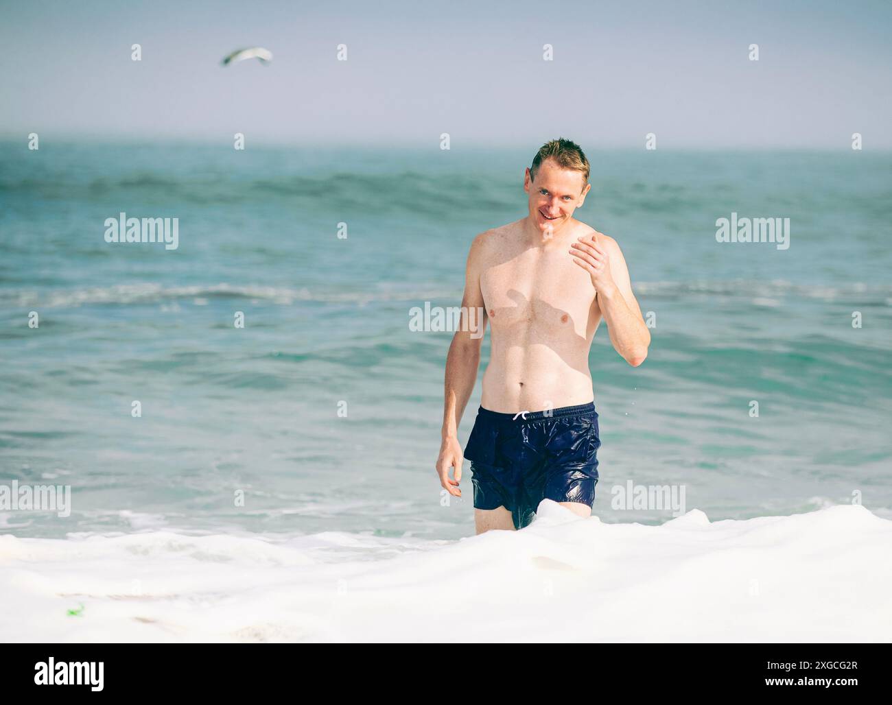 A happy man in the water at the beach Stock Photo - Alamy