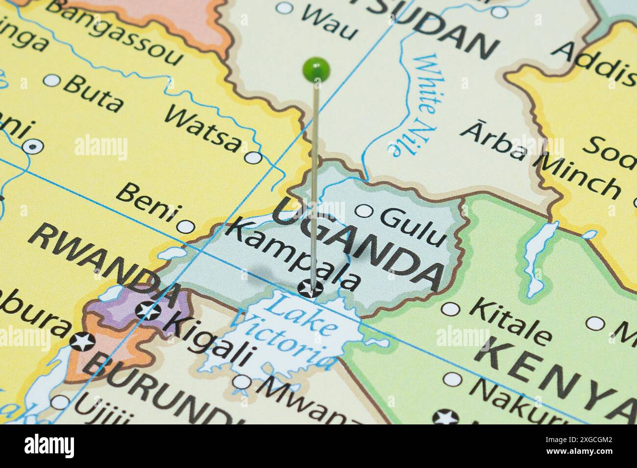 Macro photo of Kampala with a green pin needle into Uganda country ...