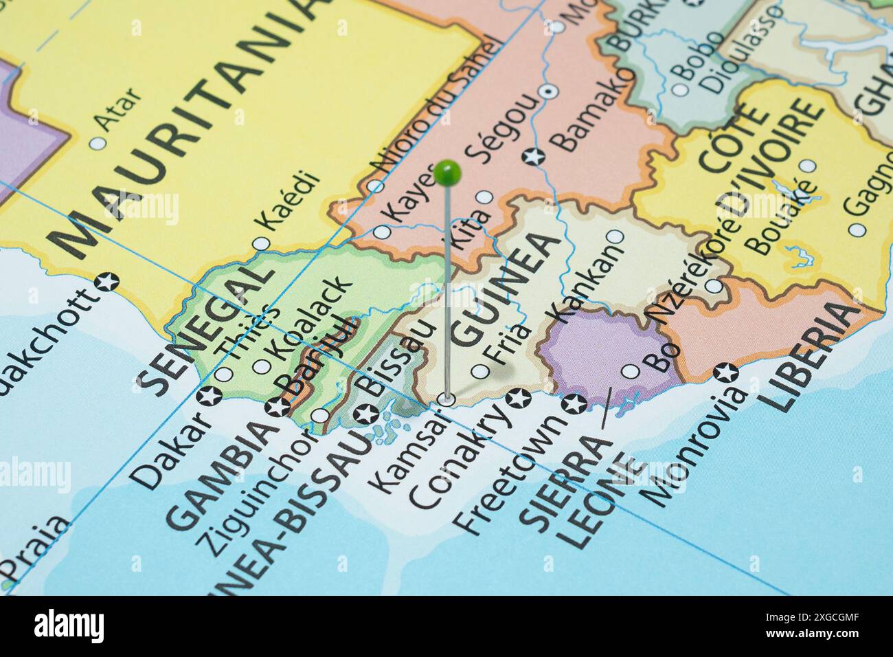 Close up to a Kamsar with a green pin needle into Guinea country ...