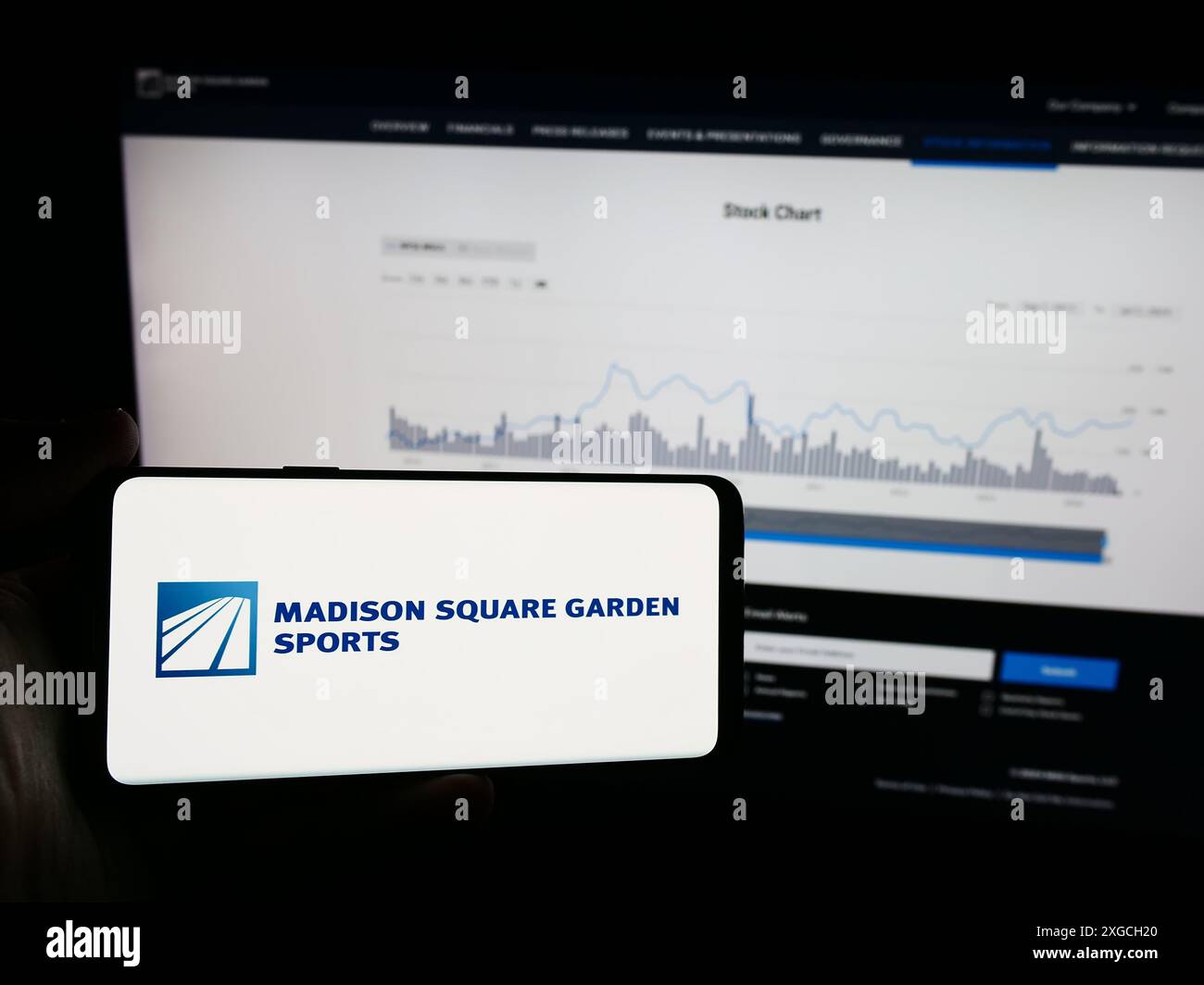 Person holding mobile phone with logo of American company Madison ...