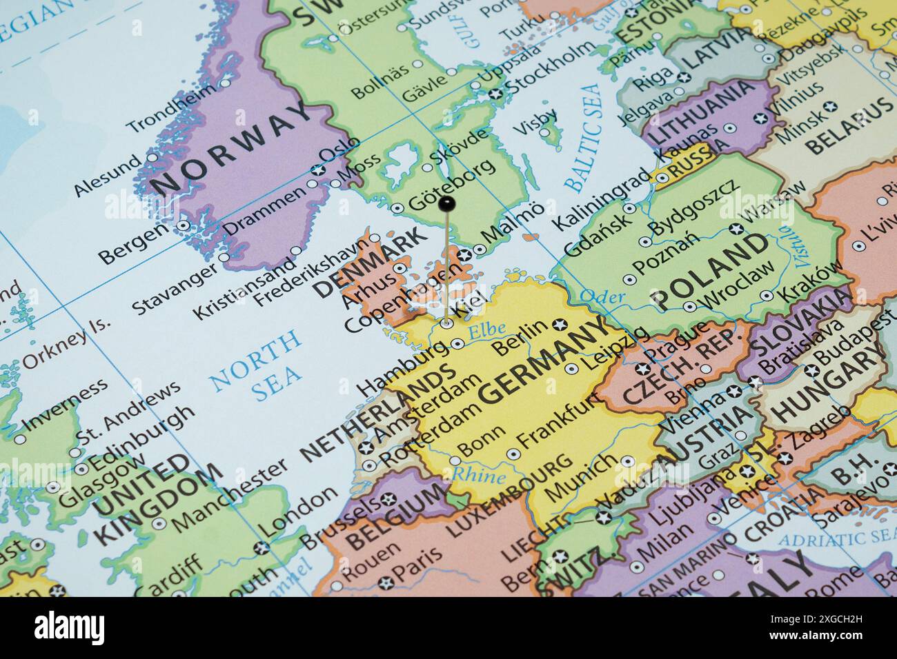 Close up to a Kiel city with a black pin needle into Germany country ...