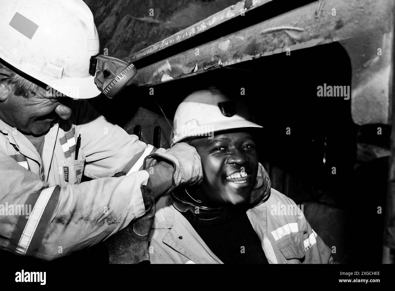 A closeup grayscale of two African workers having fun in underground Platinum Palladium Mining ...