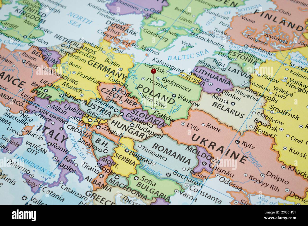 Close up to a Krakow city with a red pin needle into Poland country ...