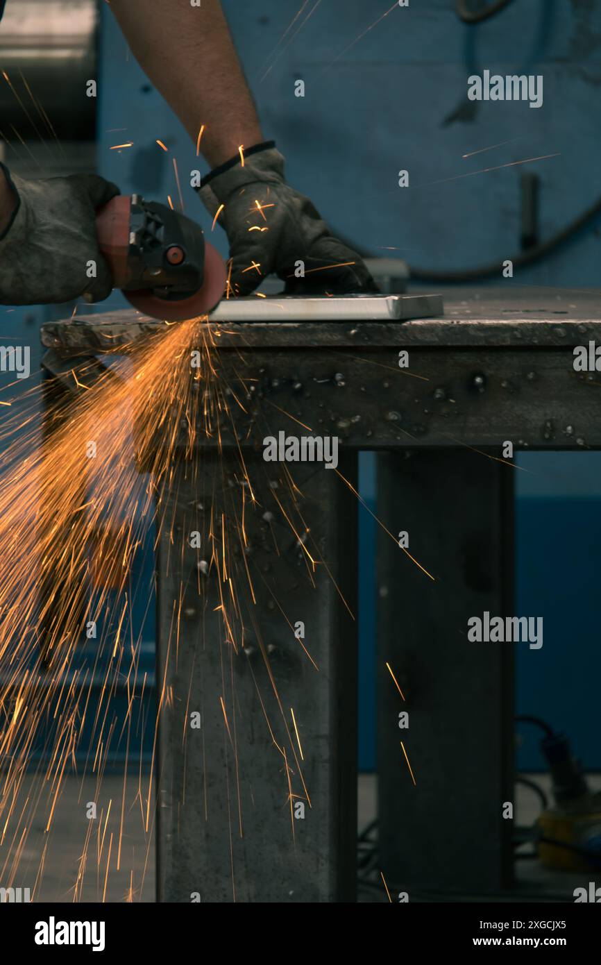 Detail of heavy industry manufacturing, sparks come out of a metal ...