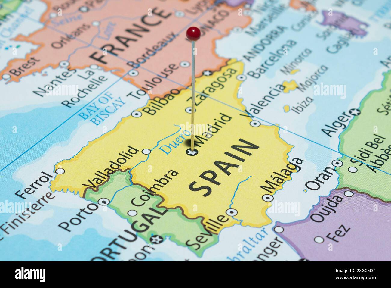 Macro photo of Madrid city with a red pin needle into Spain country ...