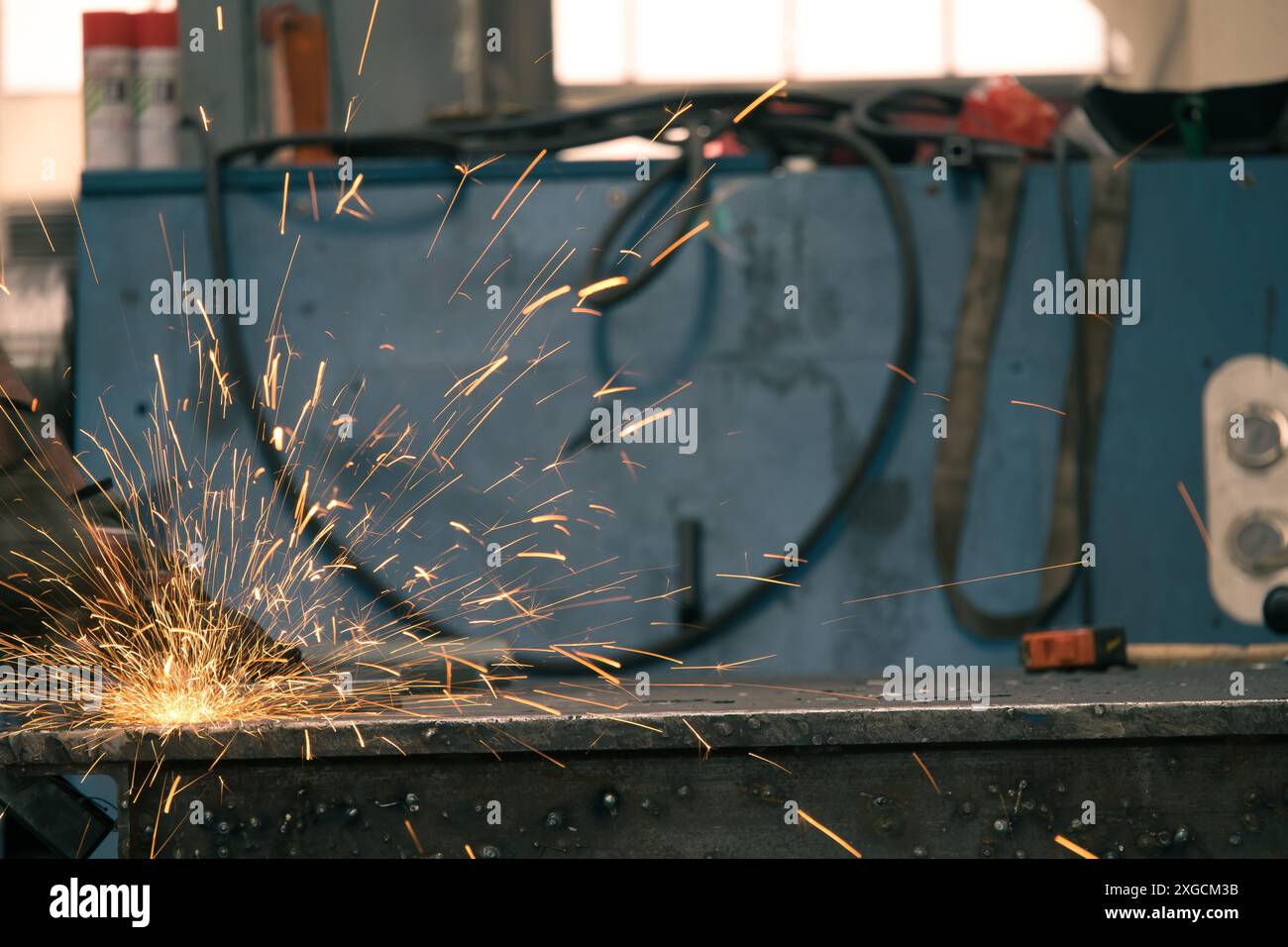 Detail of heavy industry manufacturing, sparks come out of a metal ...