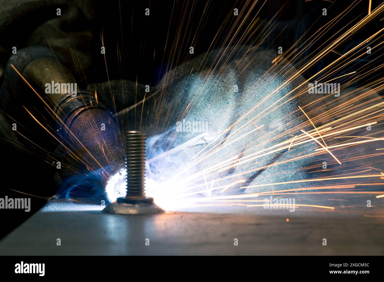 Detail of heavy industry manufacturing, sparks come out of a metal ...