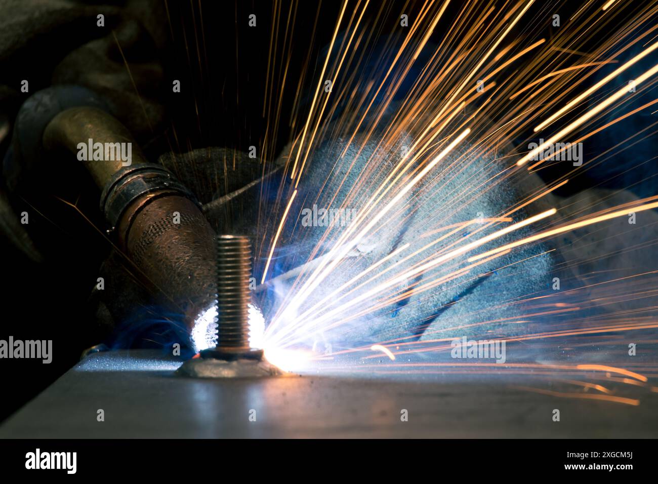 Detail of heavy industry manufacturing, sparks come out of a metal ...