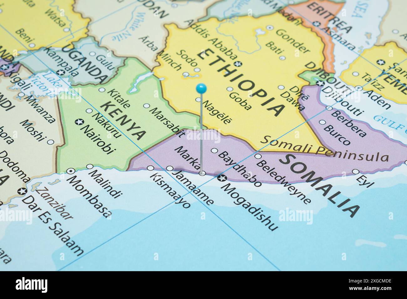 Close up to a Merca city with a light blue pin needle into Somalia ...