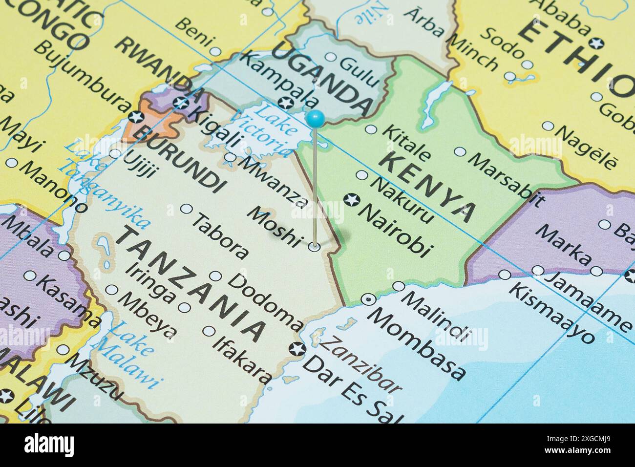 Close up to a Moshi city with a light blue pin needle into Tanzania ...