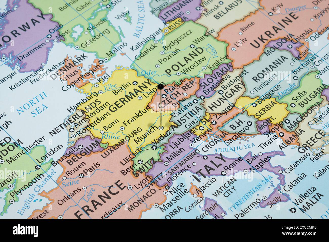 Close up to a Munich city with a black pin needle into Germany country ...